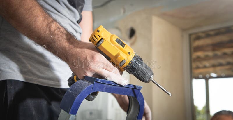 Man Holds a Drill. Doing Home Renovation Stock Photo - Image of ...