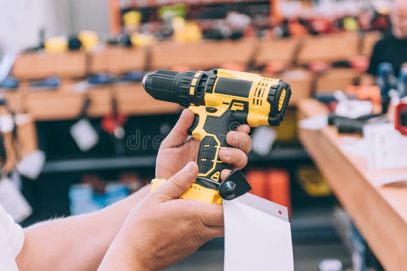 A Man Holds a Drill for Drilling in His Hands. Concept Man Selects a ...