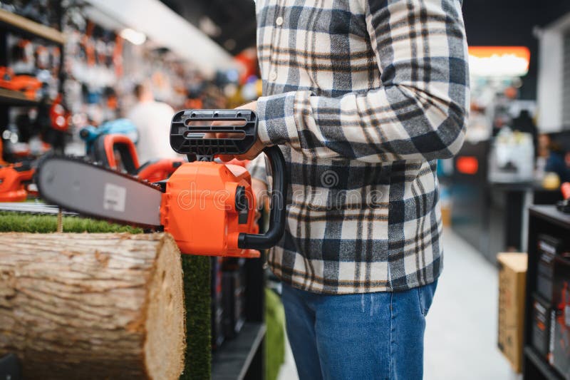 Man Holds Electric Saw in Tool Store Stock Image - Image of sale, shelf ...