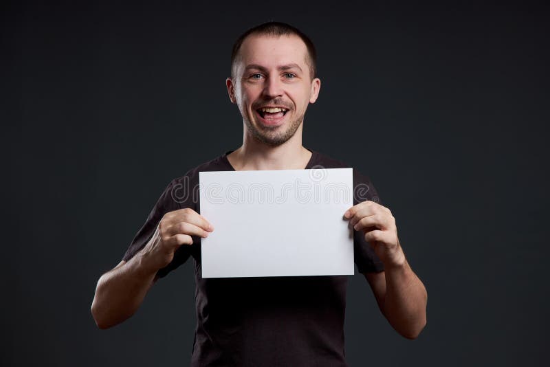 Man Holds an Empty Poster Paper Sheet in His Hands. Smile and Joy ...