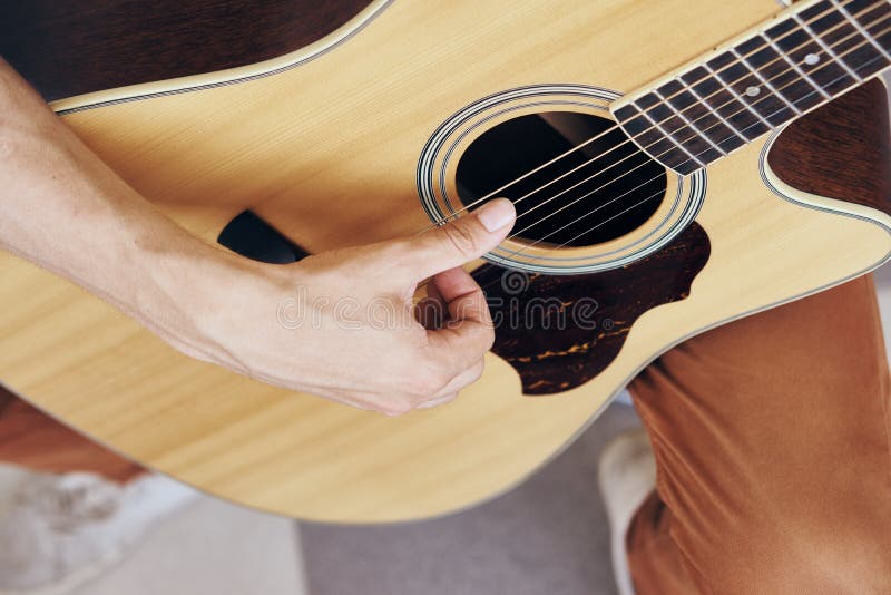 A Man Holds a Guitar, Musical Instruments, Music, Strings, a Mediator ...
