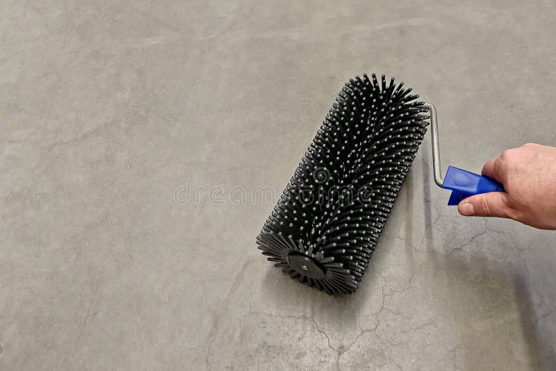 A Man Holds in His Hand a Construction Roller-building Tool Stock Photo ...
