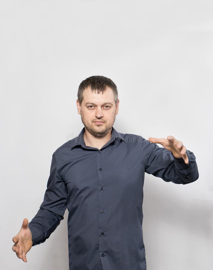 The Man Holds an Invisible Ball with His Hands, One Hand Up the Other ...