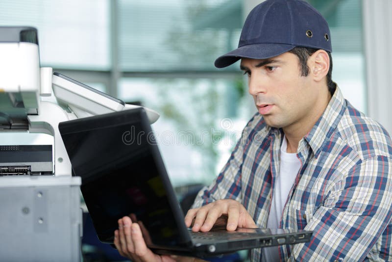 Man Holds Laptop Next To Office Printer Stock Image - Image of business ...