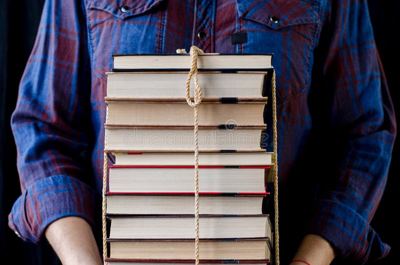 A Man Holds Many Books Tied with a Rope Stock Image - Image of pile ...