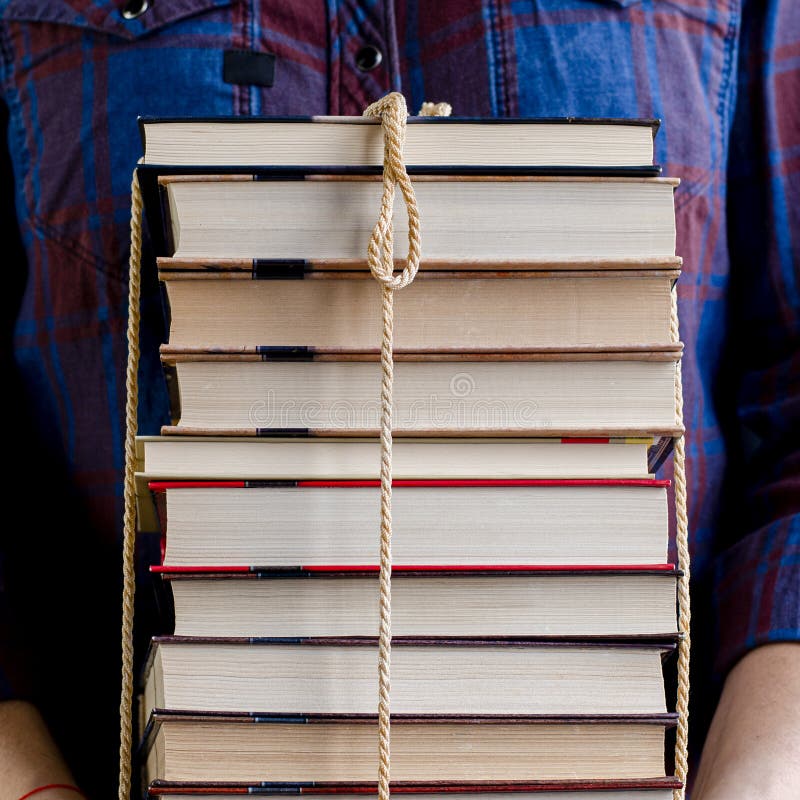 A Man Holds Many Books Tied with a Rope Stock Photo - Image of student ...