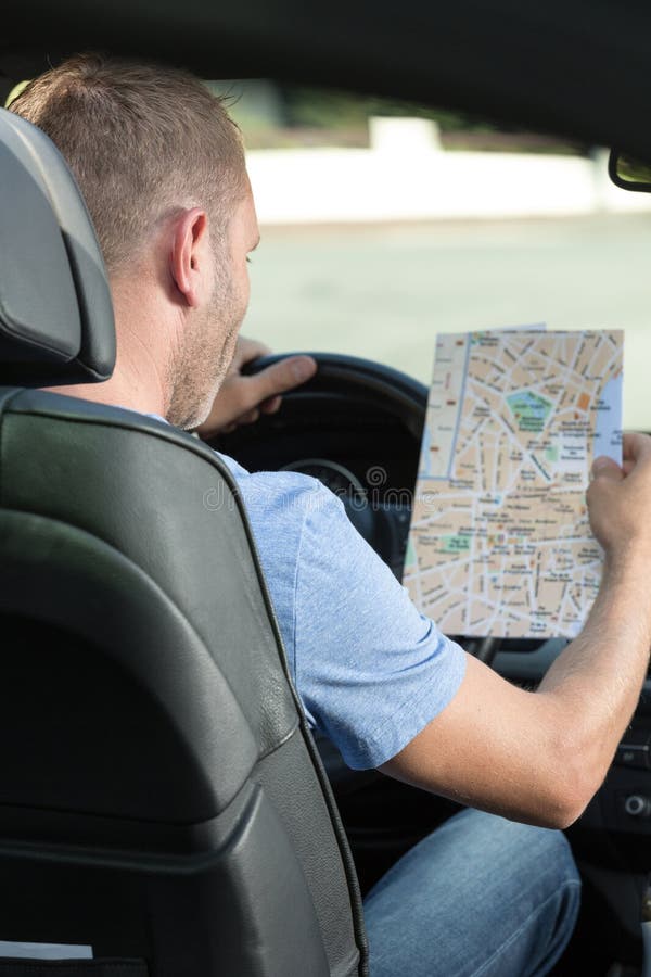 Man holds map in car stock photo. Image of looking, technology - 326321148