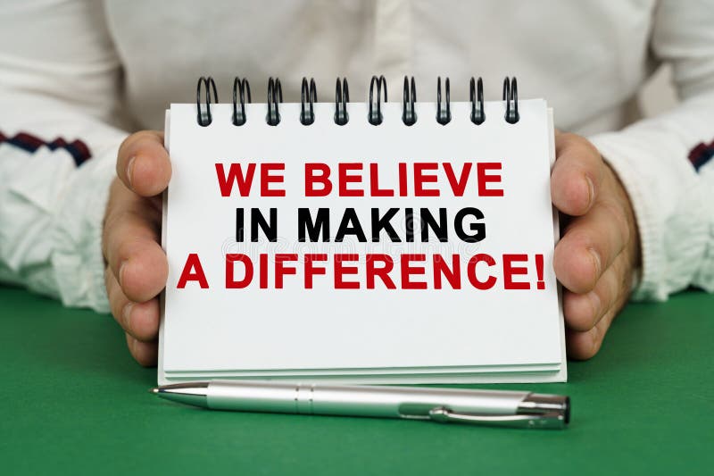 A Man Holds a Notepad in His Hands with the Inscription - we Believe in ...