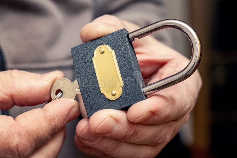 A Man Holds a Padlock with Keys in His Hand Stock Photo - Image of iron ...