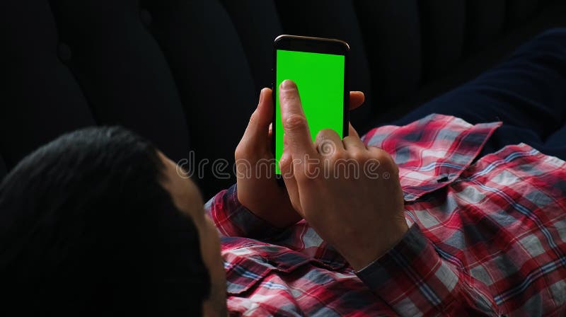 A Man Holds a Phone in His Hands with a Green Screen. Selective Focus ...
