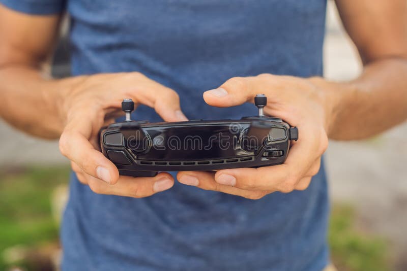 Man Holds Remote Controller with His Hands and Controls the Drone. New ...