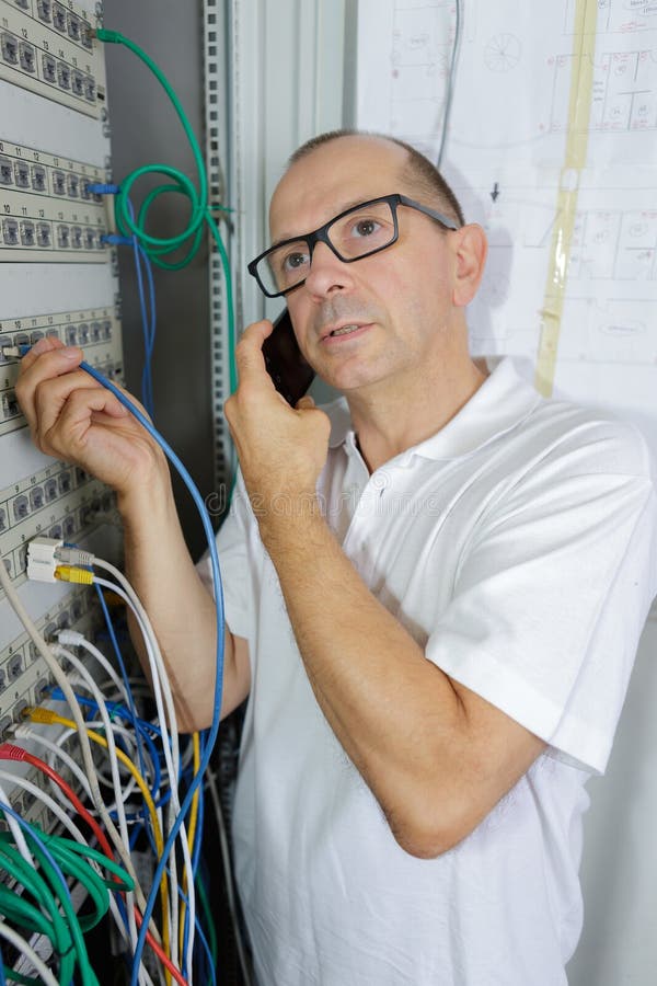 Man Holds Server Cable in Server Rack Stock Photo - Image of data ...
