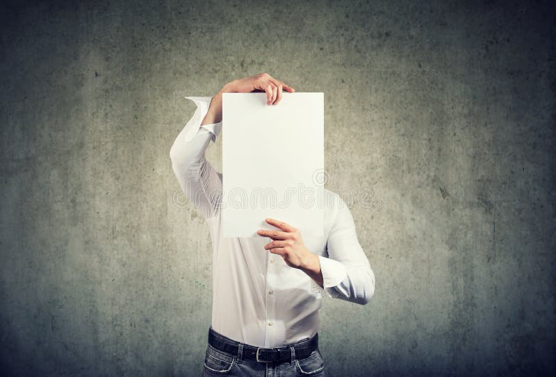 Man Holds a Sheet of White Paper in Front of His Face, Hiding His ...