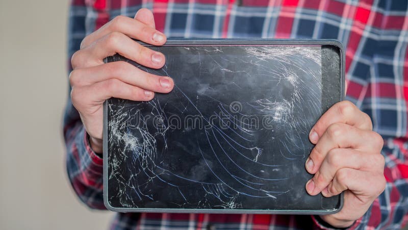 A Man Holds a Tablet with a Broken Screen Stock Photo - Image of broken ...