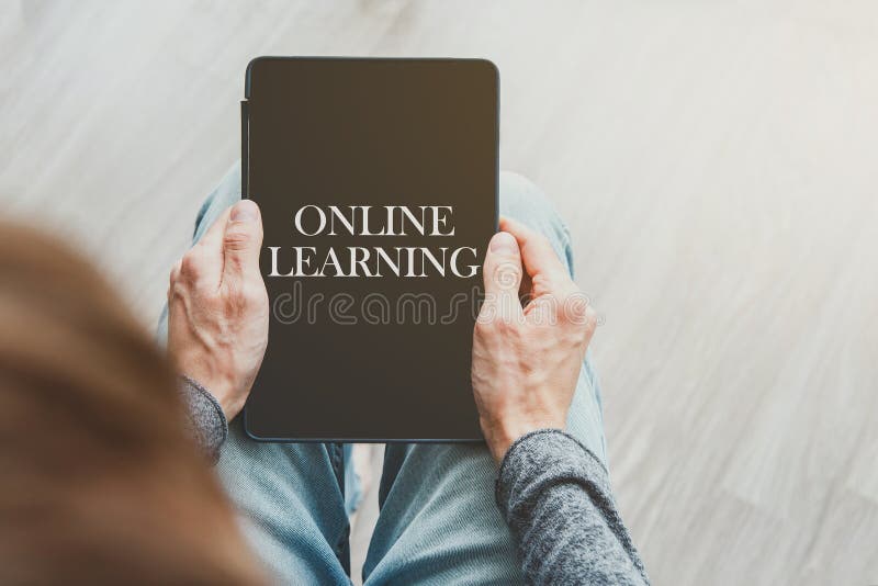 A Man Holds a Tablet with the Text Online Learning on the Screen. the ...