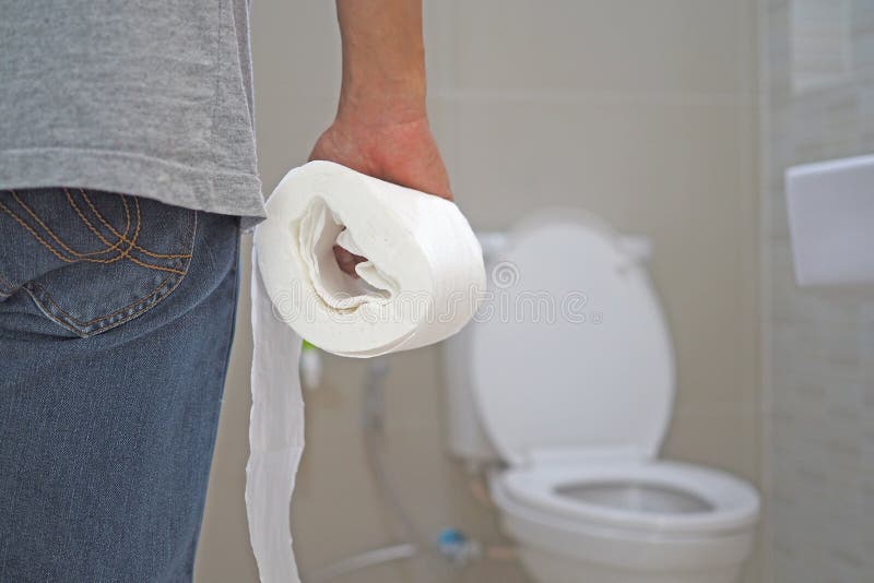 The Man Holds a Tissue Paper Roll Inside the Bathroom, Going To Stock ...