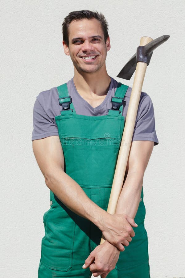 Man holds tool outdoors stock image. Image of ground - 244333073