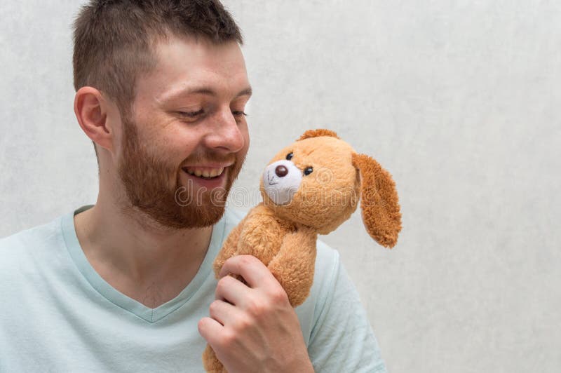 Man Holds a Toy in His Hands and Smiles. Infantilism Concept Stock ...