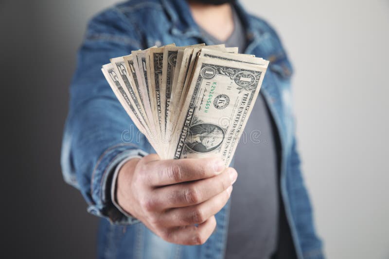 Man holds money and shows stock photo. Image of success - 215937296