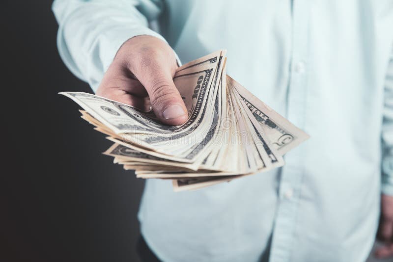 Man holds money and shows stock photo. Image of wealth - 215940770
