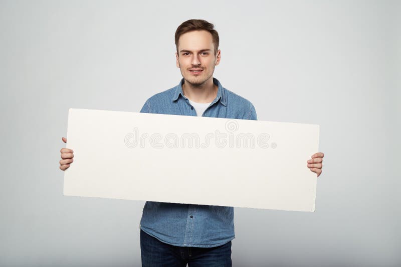 Man Holds the White Sign in a Studio White Background Stock Image ...