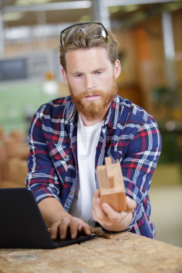 Man holds wood block stock photo. Image of work, woodwork - 260342758