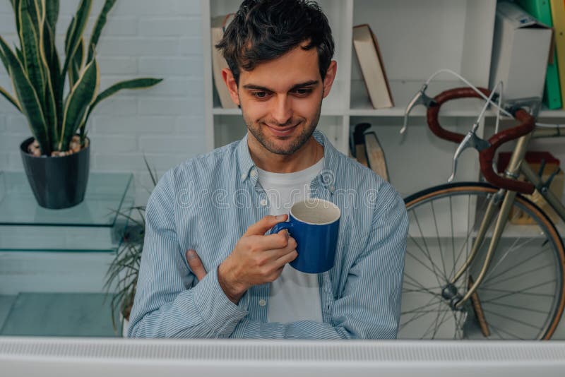 Man at Home with Cup of Coffee Looking at Computer Stock Image - Image ...