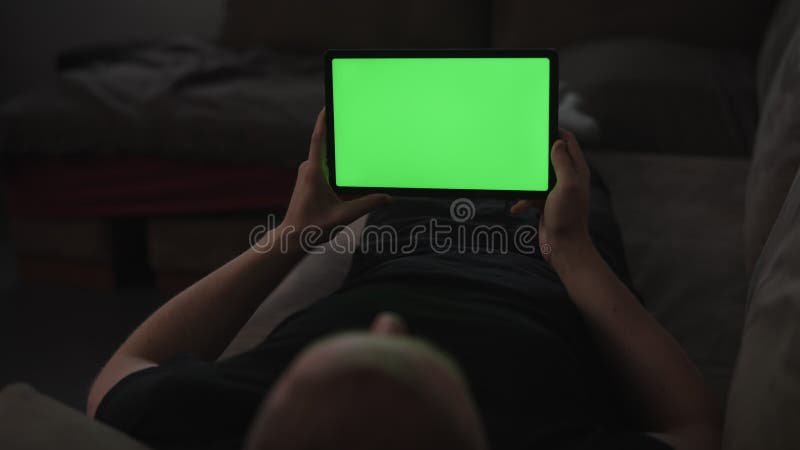 Man at Home Lying on a Couch with Tablet Pc with Green Screen Stock ...
