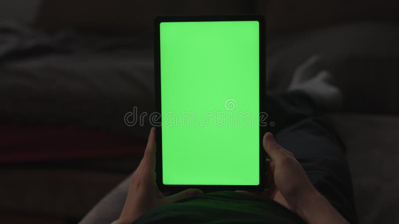 Man at Home Lying on a Couch with Tablet Pc with Green Screen Stock ... Man at Home Lying on a Couch with Tablet Pc with Green Screen Stock ...