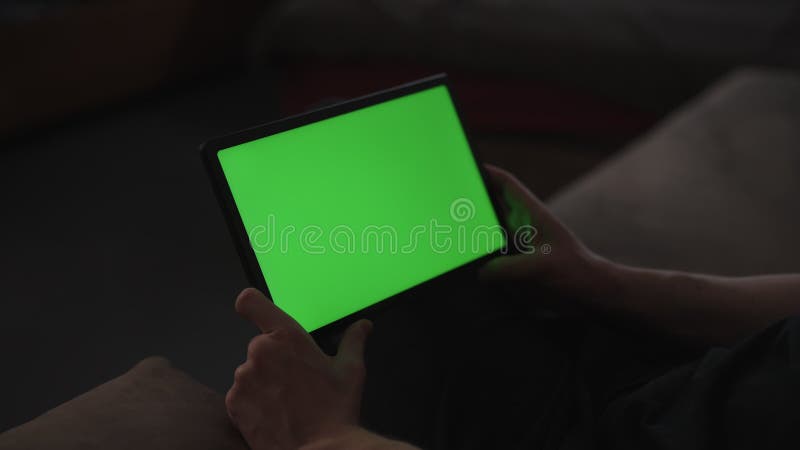 Man at Home Lying on a Couch with Tablet Pc with Green Screen Stock ... Man at Home Lying on a Couch with Tablet Pc with Green Screen Stock ...