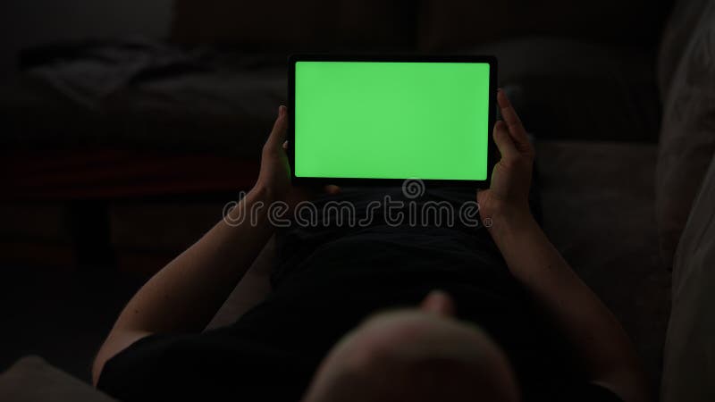 Man at Home Lying on a Couch with Tablet Pc with Green Screen Stock ...
