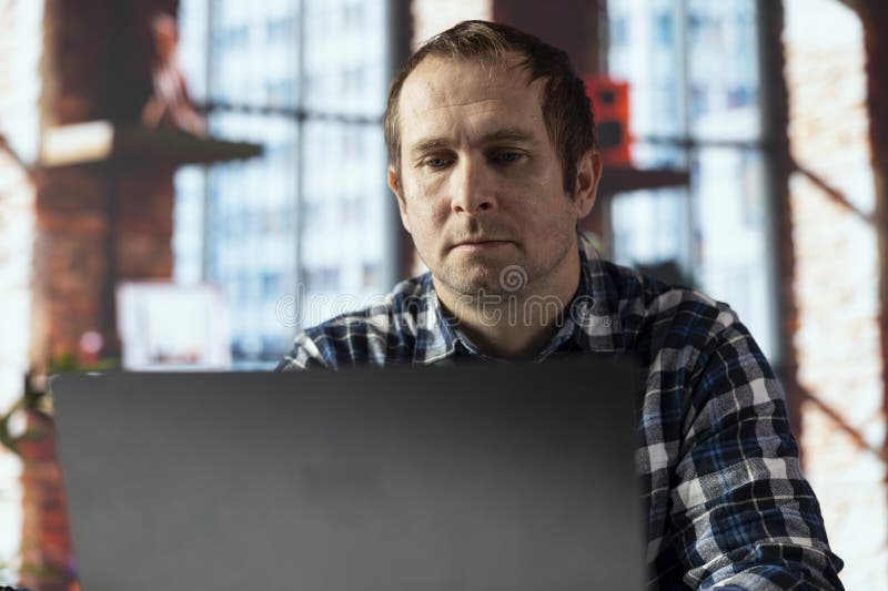Man at Home Office Desk Using Laptop, Preparing Presentation Slides ...
