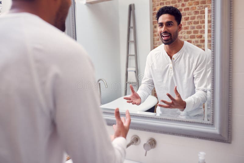 Man at Home Practising Giving Speech or Presentation in Bathroom Mirror ...