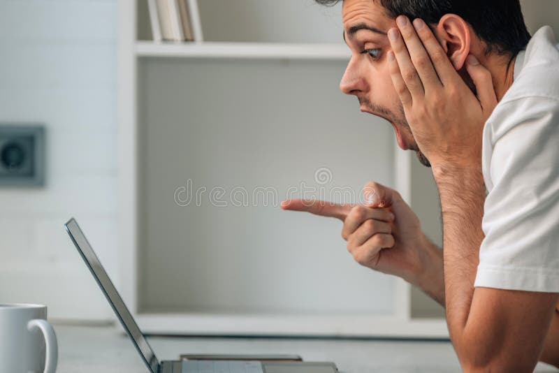 Man Reacting with Surprise Looking at Laptop Stock Image - Image of ...