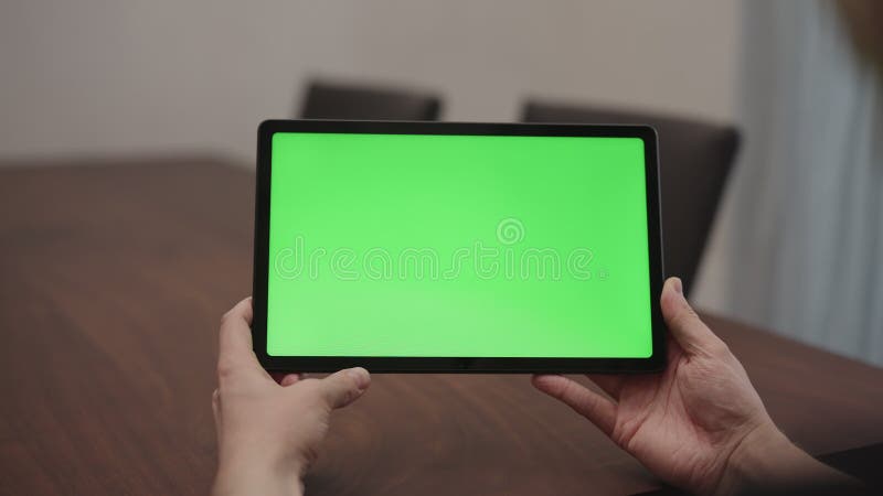 Man at Home Using Tablet Pc with Green Screen while Sitting at the ... Man at Home Using Tablet Pc with Green Screen while Sitting at the ...
