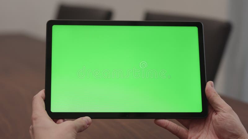 Man at Home Using Tablet Pc with Green Screen while Sitting at the ...