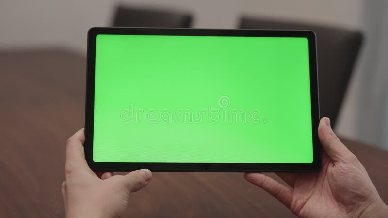 Man at Home Using Tablet Pc with Green Screen while Sitting at the ...