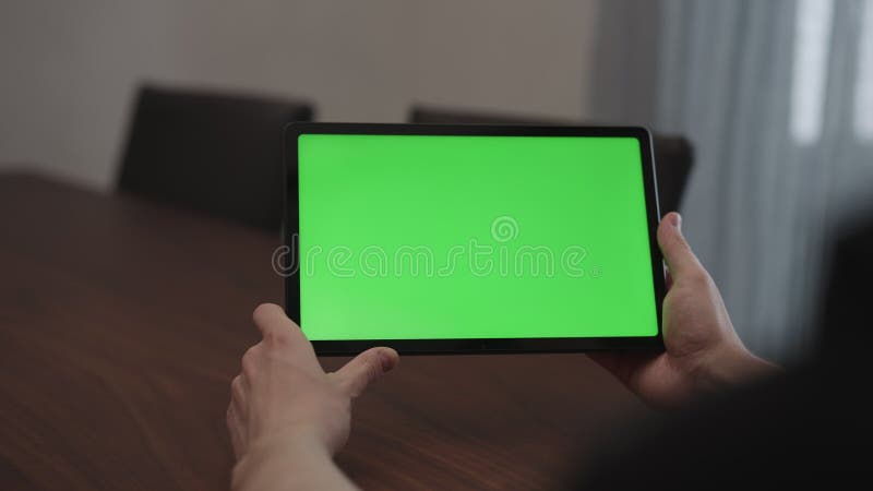 Man at Home Using Tablet Pc with Green Screen while Sitting at the ...