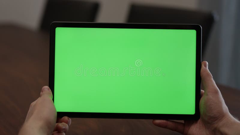 Man at Home Using Tablet Pc with Green Screen while Sitting at the ...