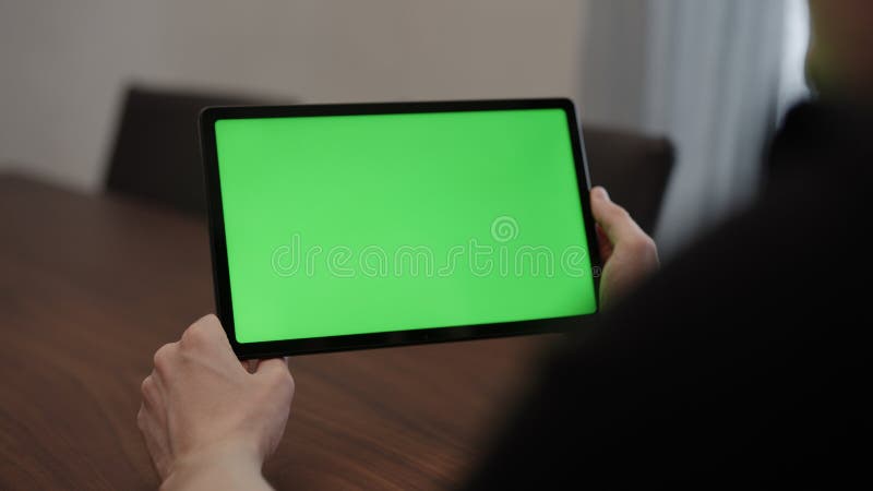 Man at Home Using Tablet Pc with Green Screen while Sitting at the ...
