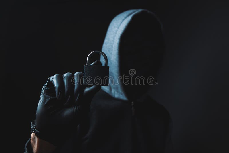 Man with a Hood Holds a Padlock in His Hand Stock Photo - Image of ...