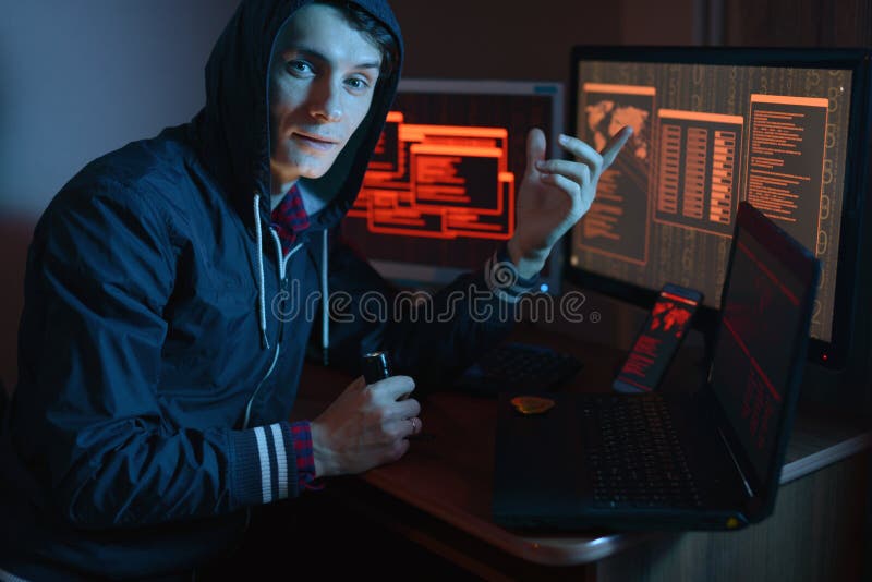 Man In The Hood Looking In The Camera Hacker Attacks And Stealing Access Databases With