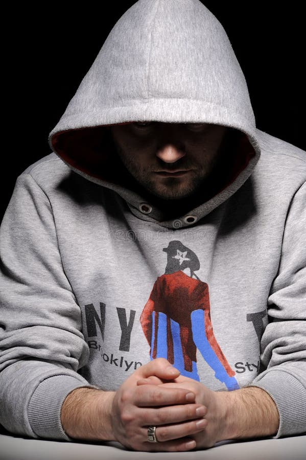 Man in Hooded Jacket Sitting at the Table Stock Photo - Image of danger ...