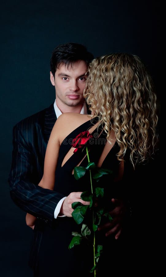 Man Hug His Woman and Holding Rose Stock Photo - Image of blonde, adult ...