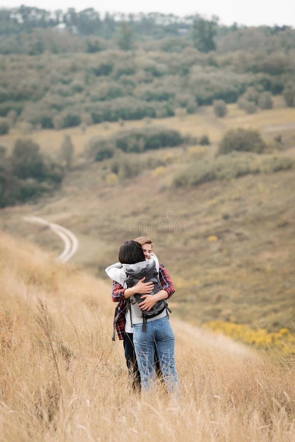 Man Hugging Girlfriend with Backpack during Stock Photo - Image of ...