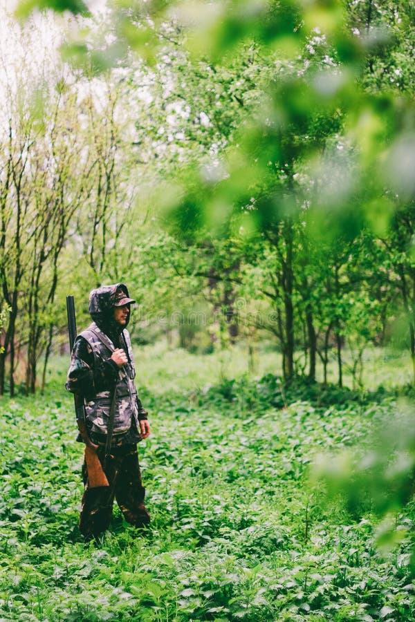 A Man Hunter Take Aim for a Shot from a Carbine, Hunting in a Spring ...