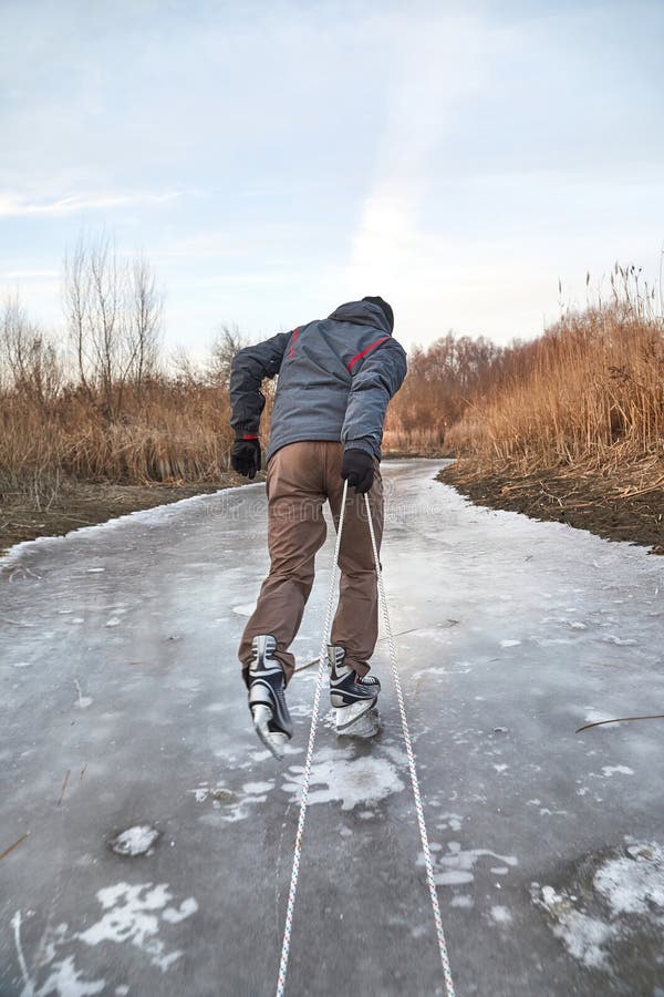 Man Ice Skating Pulling Sledge on Ice Stock Image - Image of outdoor ...