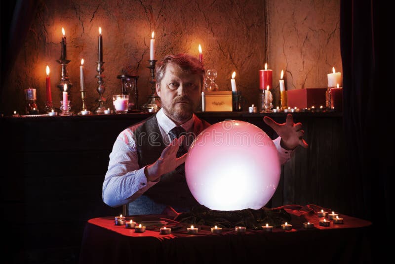 Man with Illuminated Crystal Ball Stock Image - Image of blue, candle ...