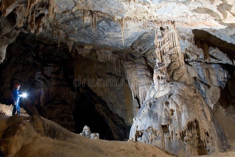 Alava, Spain, November 1, 2008: Young Man Exploring a Cave with Torch ...