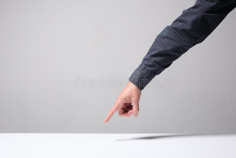 Man` Index Finger Pointing on an Empty White Table with Copy Space for ...
